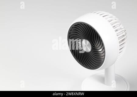 Small white plastic desktop fan side view, isolated on white background ...