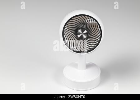 Small white plastic desktop fan side view, isolated on white background ...