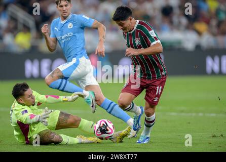 Manchester City goalkeeper Ederson dives at the feet of Fluminense's ...