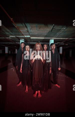 a group of devil worshipers in all black clothes and transparent veils ...