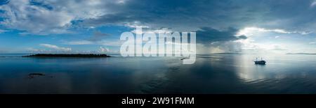Rain clouds drift across the scenic and colorful Indonesian seascape ...
