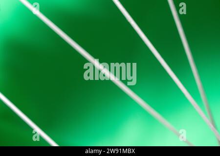 Bicycle wheel spoke with threaded head detail on the rim on a green ...