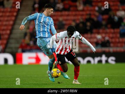 Sunderland's Eliezer Mayenda (left) and Coventry City's Matt Grimes ...