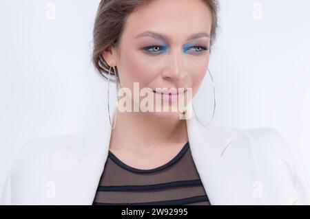 Portrait of a beautiful girl with a defiant make-up. White background ...