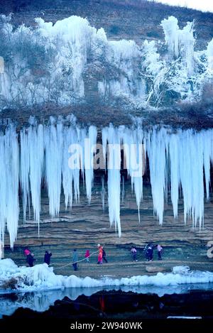 ZAOZHUANG, CHINA - DECEMBER 24, 2023 - Tourists view an icefall at ...