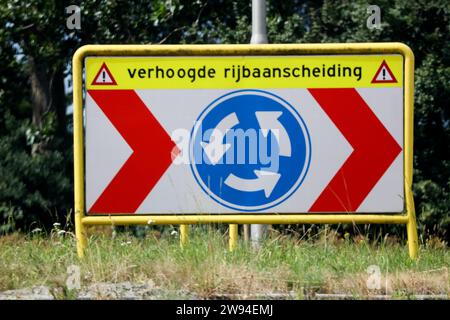 Sign for a roundabout and warning for Elevated lane separation in the ...