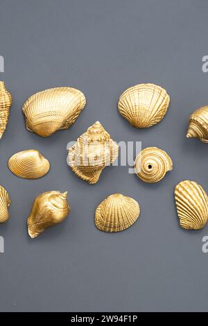 Gold sea shells arrangement Stock Photo - Alamy