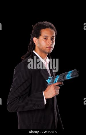 Powerful young man with a gun Stock Photo - Alamy