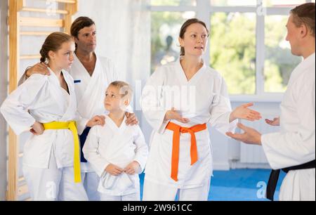 After completing family session and karate training, parents talk with ...