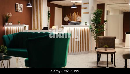Crane shot of empty stylish hotel foyer with check in reception counter ...