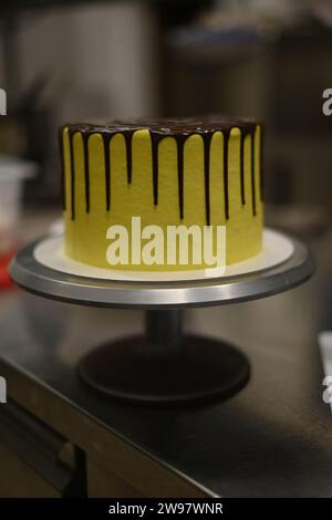 pastry chef smooth prepare sculpt yellow dripping frosted layered dark ...