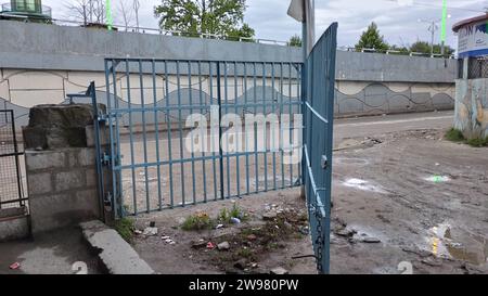 An rustic picket fence and weathered building sit atop a hilltop in ...