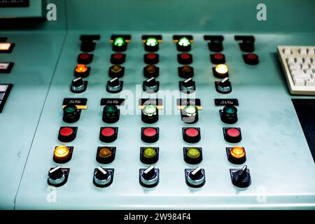Industrial control panel with illuminated buttons glowing with ...
