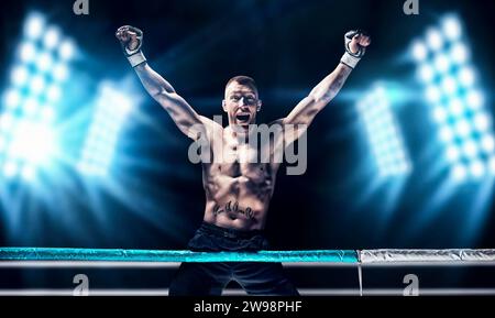Kickboxer posing in the ring. The athlete climbed the ropes and took a ...