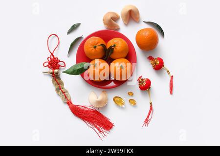 Plate with fortune cookies and mandarins on yellow background, closeup ...