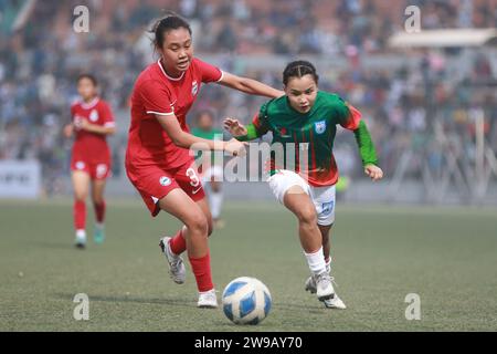Bangladeshi midfilder Ritu Porna Chakma (Green) try to takes control as ...