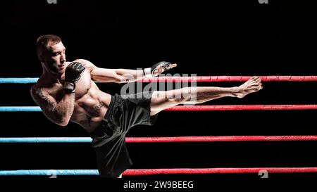 Kickboxer posing in the ring. Middle Kick with a burning foot. The ...