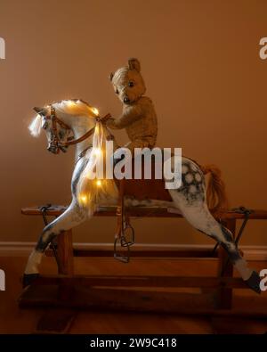 Teddy bear riding Rocking Horse Stock Photo - Alamy