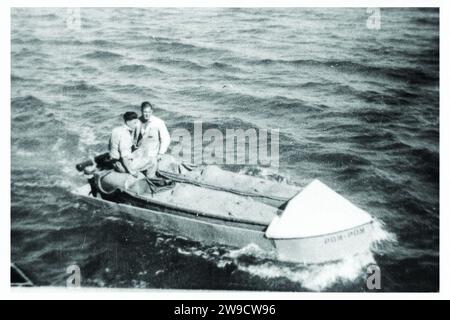 A pair of Sleeping BEauty mini submarines are loaded into their tender ...