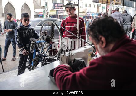 A Palestinian tailor named Abu Adam Dolah, uses a pedaled sewing ...