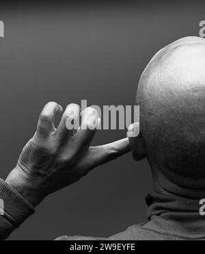 deafness suffering from hearing loss on grey black background with ...