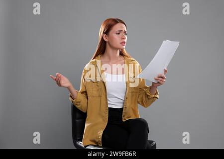Casting call. Emotional woman with script performing on grey background ...