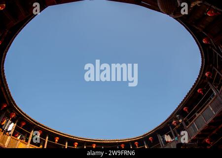 The sky above the round buildings of Hekeng Tulou Cluster in the early ...