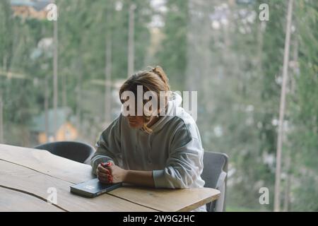A Woman is praying near the panoramic window Stock Photo - Alamy