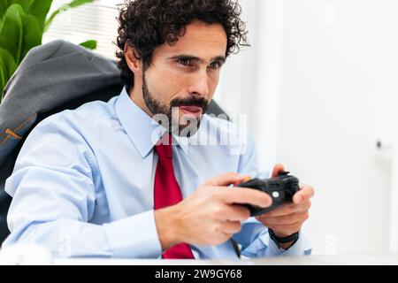 Businessman playing videogames in his office Stock Photo - Alamy