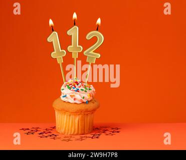 Birthday card - Number 112 candle in orange background Stock Photo - Alamy