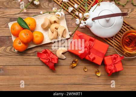 Gift boxes with fortune cookies, mandarins and Chinese symbols on ...