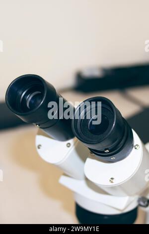 Black microscope on the wooden desktop close up Stock Photo - Alamy