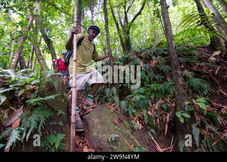 A woman and her guide hike Segment 3 of the Waitukubuli National Trail ...