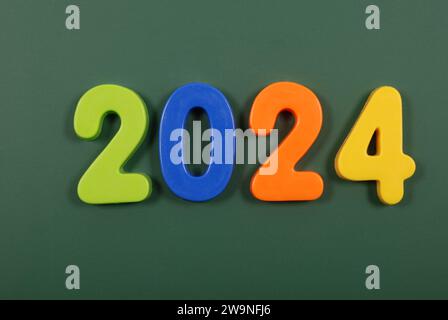 2024 year written in bright plastic magnetic letters stuck on a ...