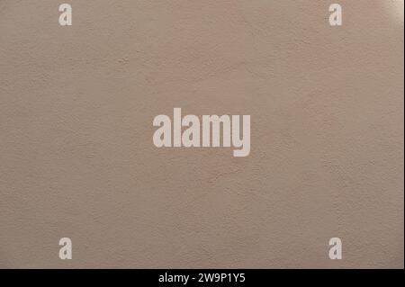 A subtle and smooth peach-colored plaster wall, perfect as a minimalist ...