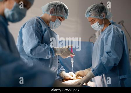Surgeon makes an injection during an operation Stock Photo - Alamy