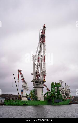 the Orion Offshore Heavy Lift crane moving wind turbine monopiles from ...