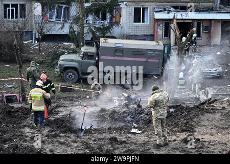 People examine the damage after shelling of a shopping center, in Kyiv ...
