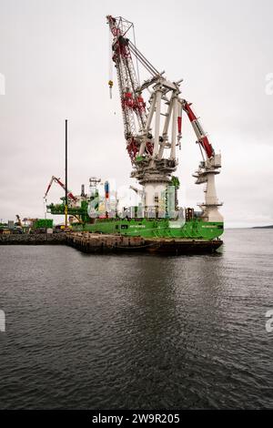 the Orion Offshore Heavy Lift crane moving wind turbine monopiles from ...