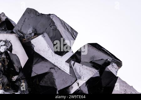 Magnetite (natural magnet) crystal macro detail white isolated ...
