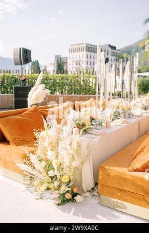 Long served table with plates, glasses, napkins and chairs Stock Photo ...
