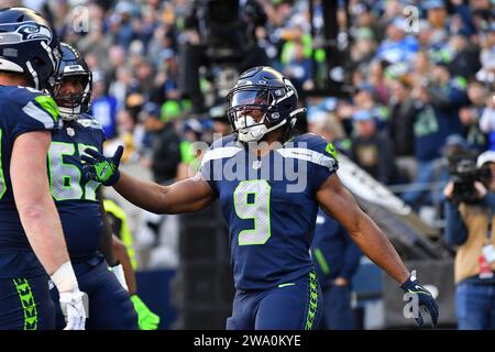 Pittsburgh Steelers running back Kenneth Gainwell (14) takes a hit from ...