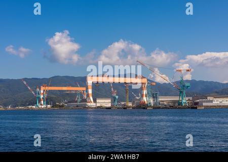 Shipyards within Nagasaki bay Japan, industrial landscape shore harbour ...