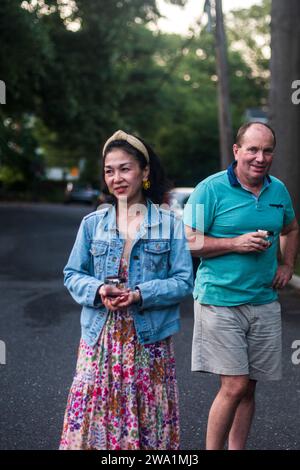 Neighbors getting together on holiday block party Stock Photo - Alamy