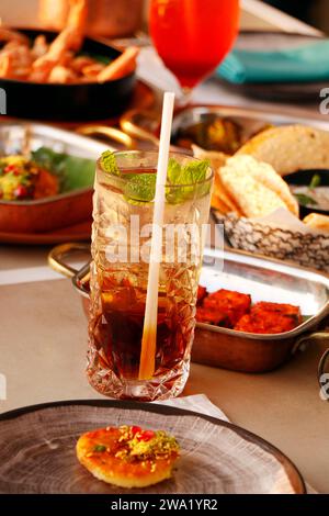 cocktail drinks and paired foods on a dining table Stock Photo - Alamy