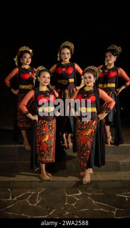 a group of dancers stand and unite in red costumes that show unity at ...