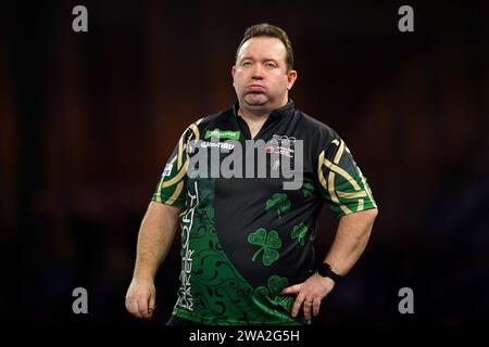 Brendan Dolan in action against Luke Littler (not pictured) on day ...