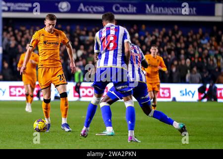Liam Delap of Hull City plays the ball away from Ryan Andrews of ...