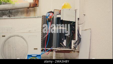 Handheld camera shot of damaged air cooling unit in need of fixing ...