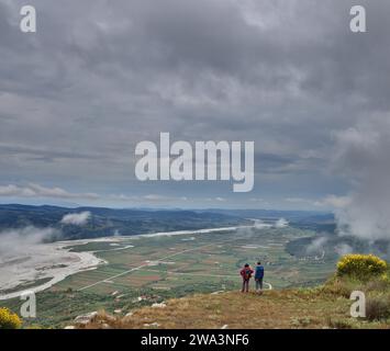 View from the Byllis Archaeological Park over flowering broom into the ...